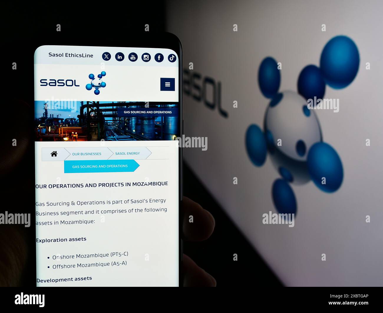 Person holding smartphone with webpage of South African energy company ...