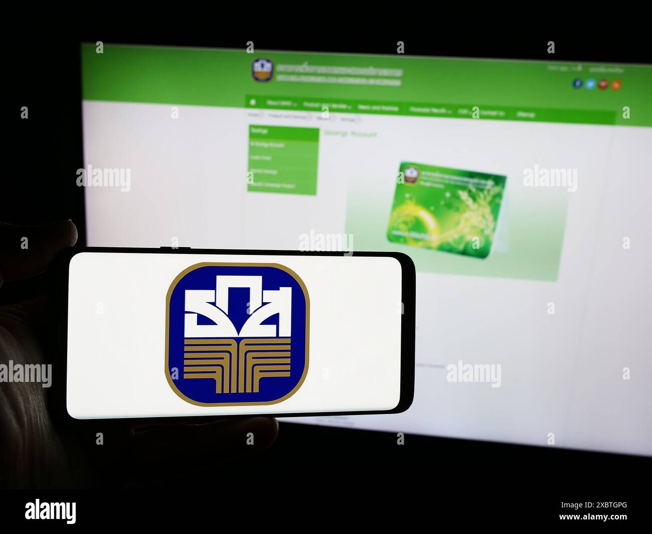 Person holding smartphone with logo of Bank for Agriculture and ...