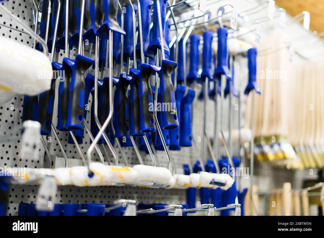 A store display of paint brushes and rollers. The display is organized ...