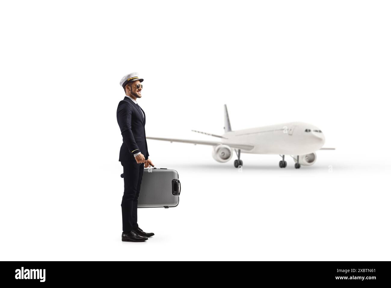 Full length profile shot of a pilot in a uniform standing with a ...