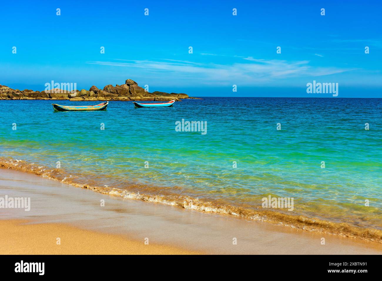 Primitive fishing canoes on the sea waters of Ilhabela Island on the ...