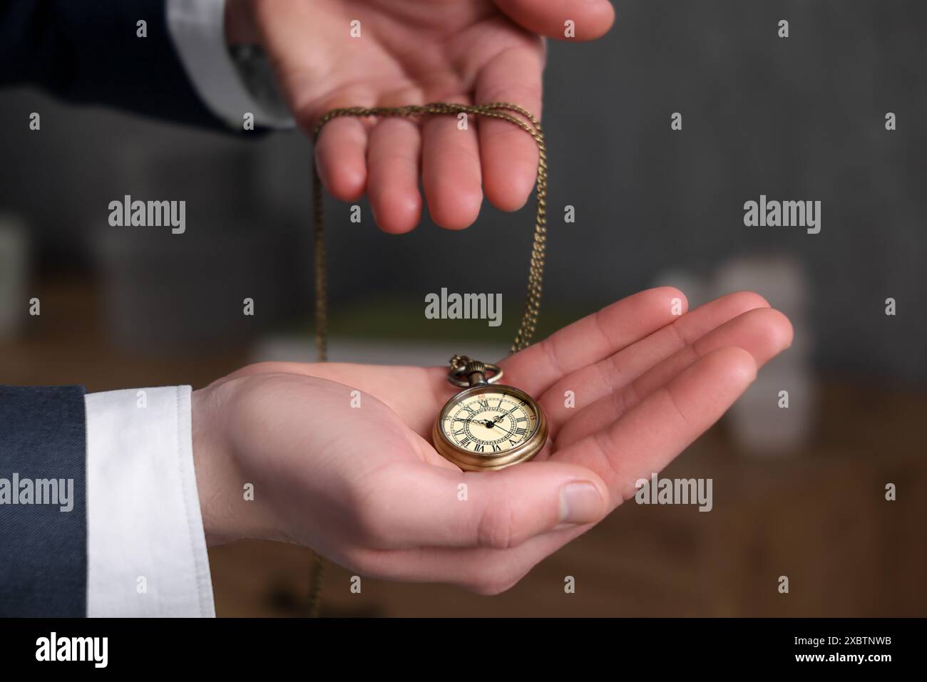 Hand holding watch on chain hi-res stock photography and images - Alamy