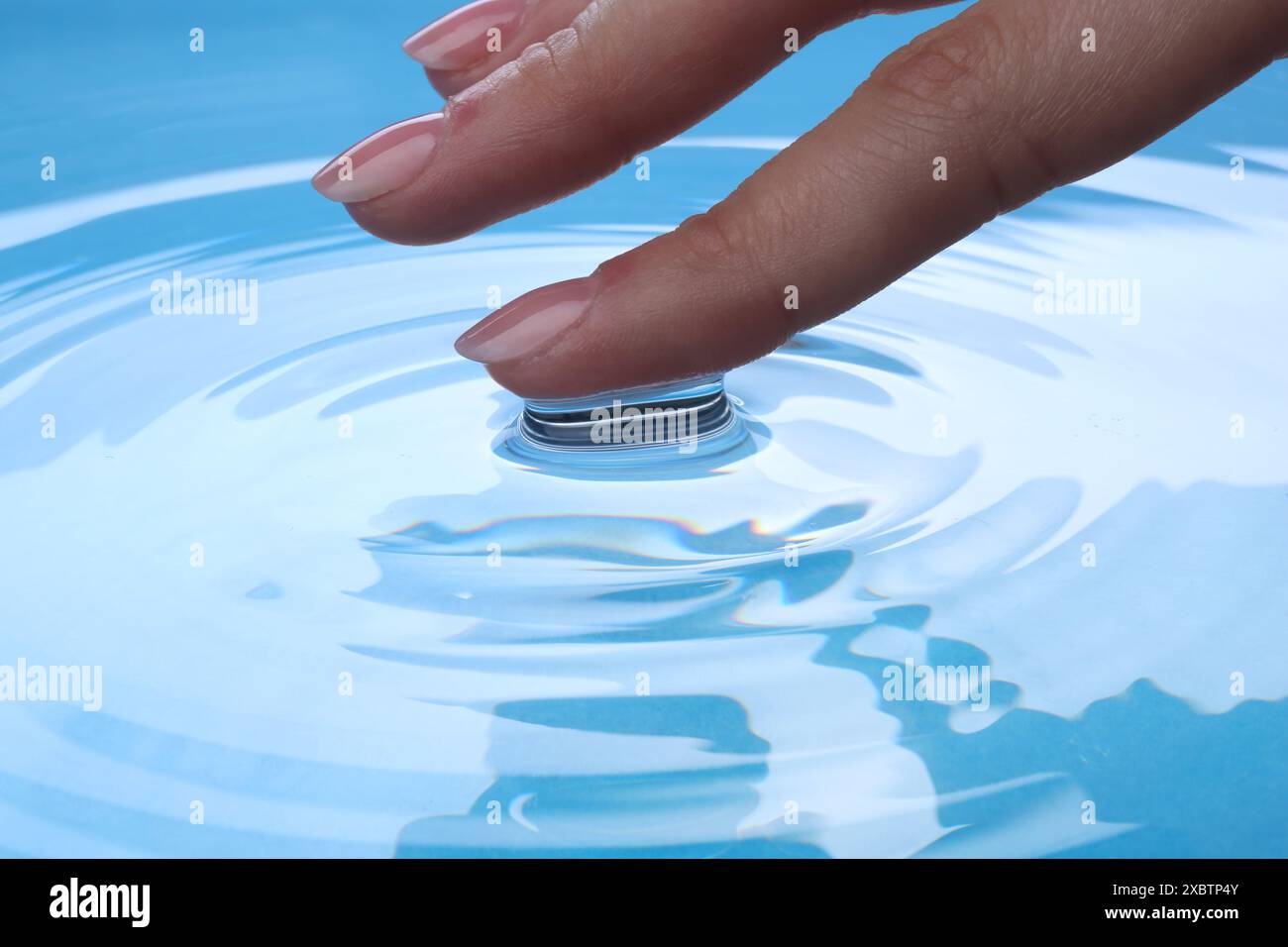 Woman touching clear water, closeup. Making ripples Stock Photo - Alamy