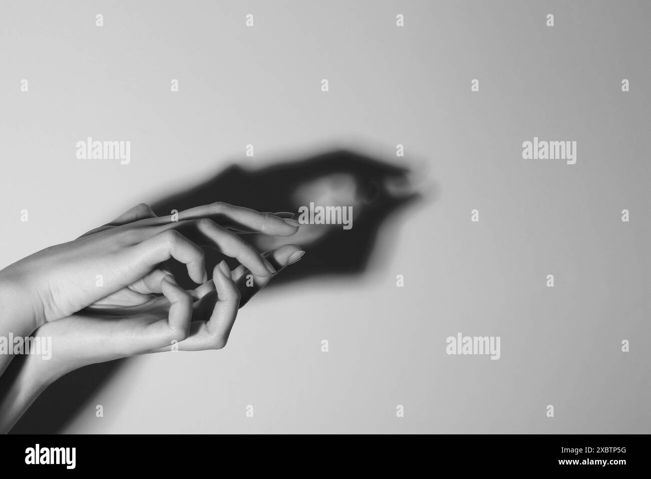 Shadow puppet. Woman making hand gesture like crocodile on light ...