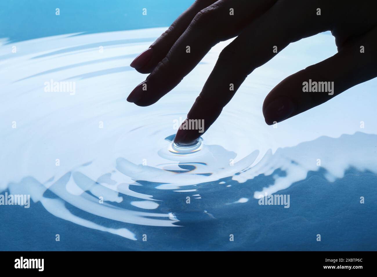 Woman touching clear water, closeup. Making ripples Stock Photo - Alamy