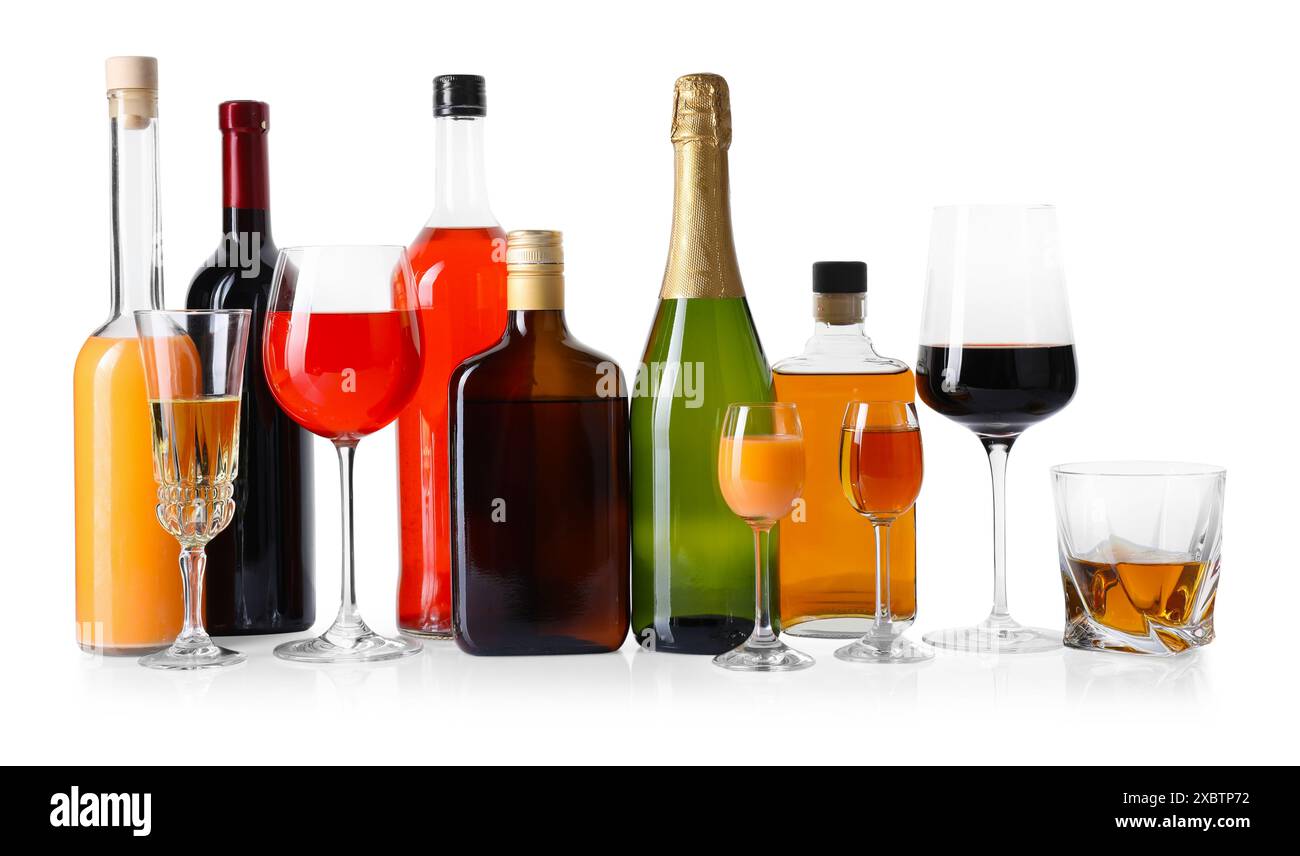 Bottles and glasses with different alcoholic drinks isolated on white ...