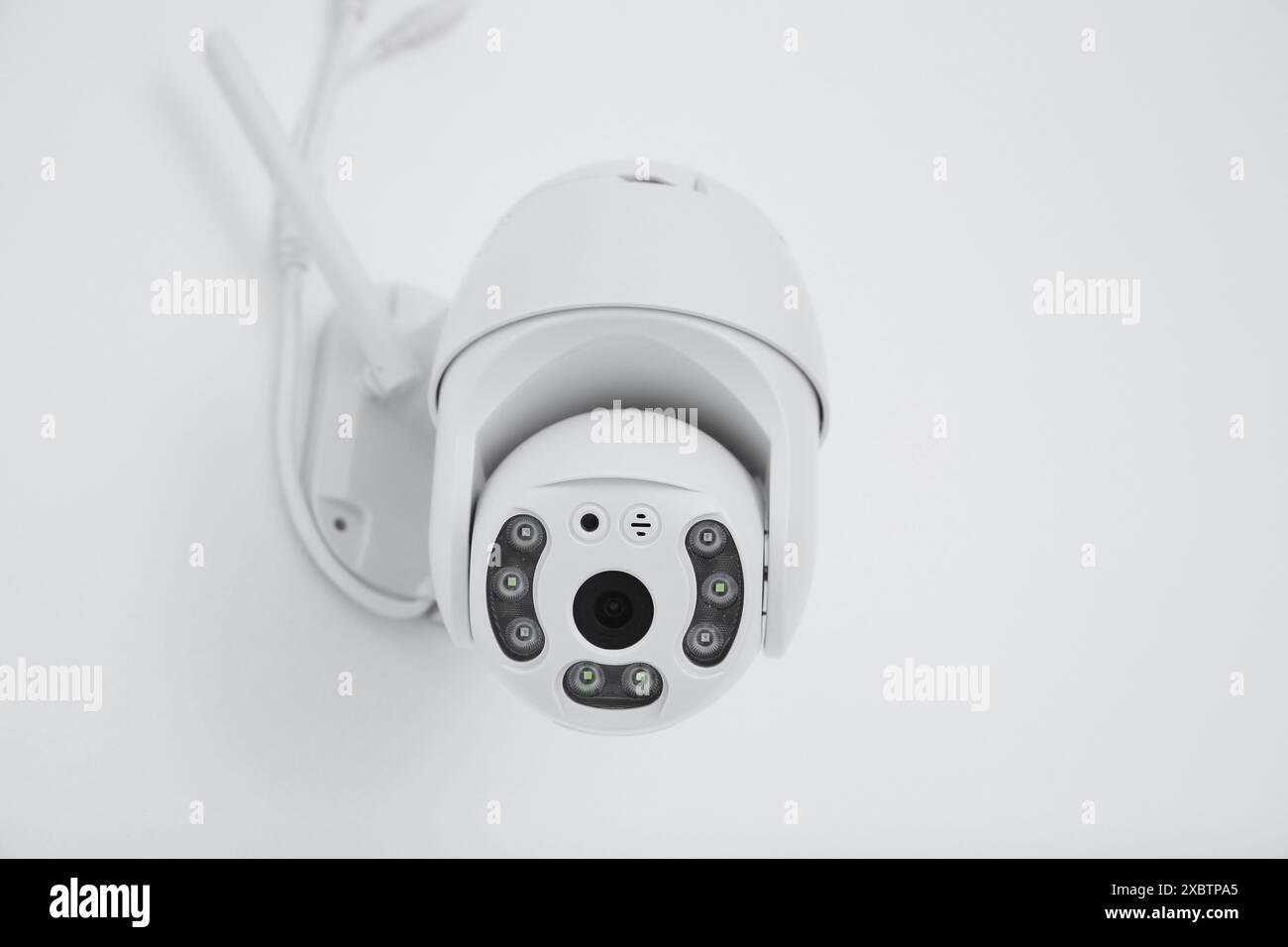 White CCTV camera on wall, closeup. Home security system Stock Photo ...
