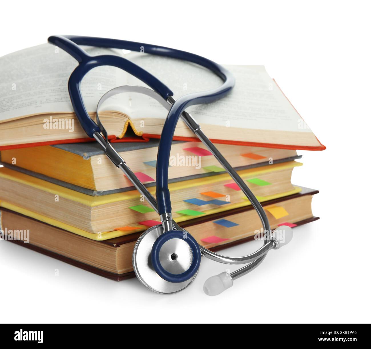 Stethoscope on stack of books against white background Stock Photo - Alamy