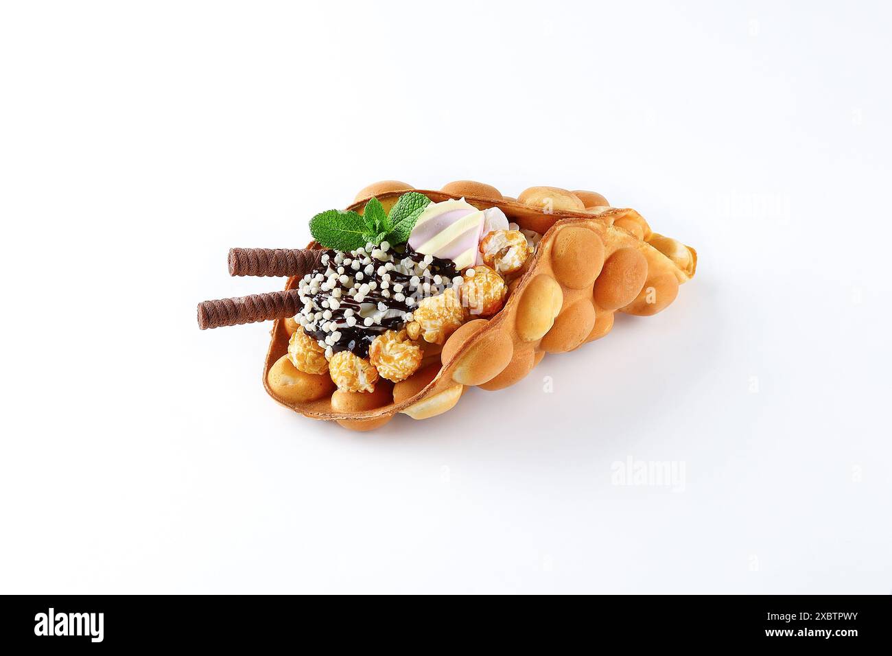 Delicious sweet bubble waffle on white background Stock Photo - Alamy