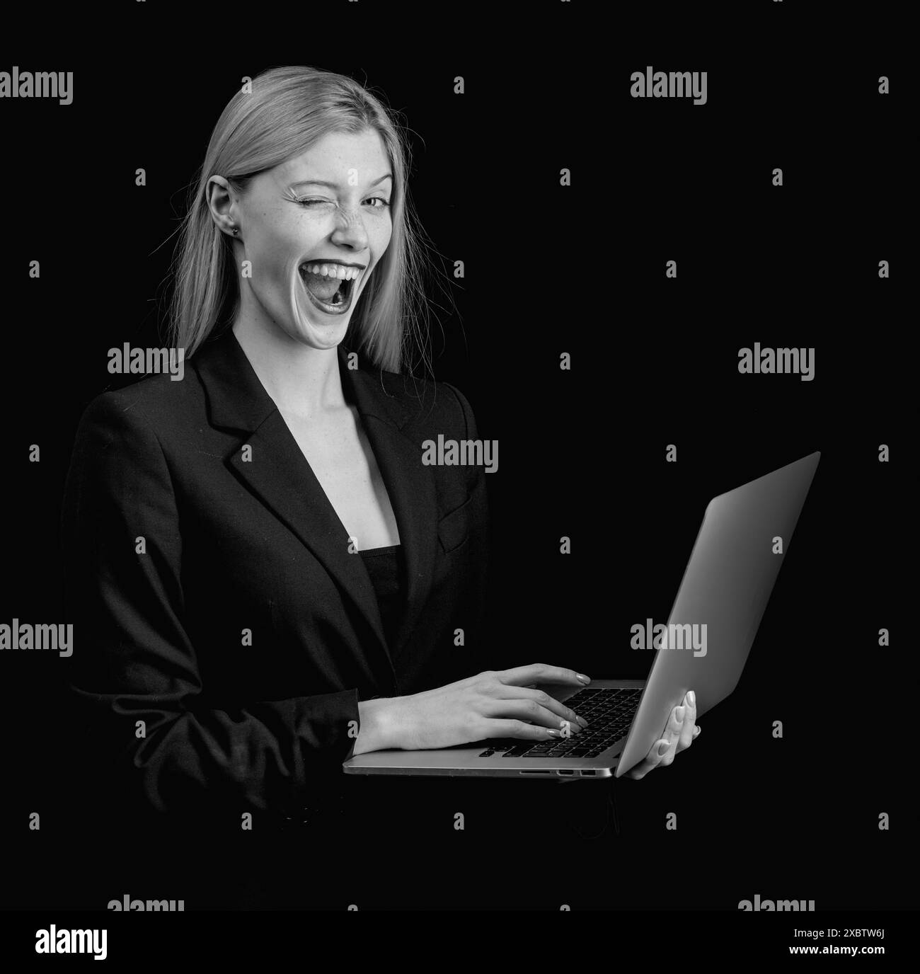 Funny Secretary. Young Secretary holding laptop on black background ...