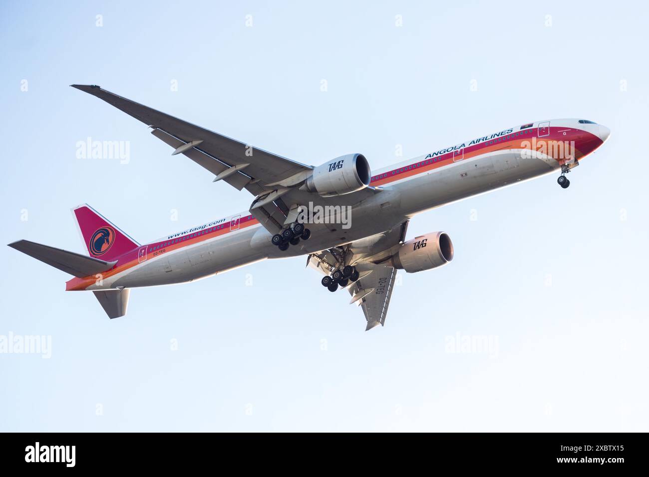 White Boeing 777 airplane belonging to TAG Angolian airlines flies ...