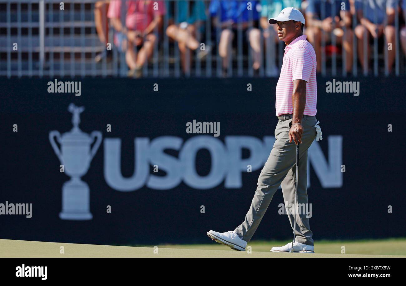 Tiger Woods waits to putt on the fourteenth green during the first ...