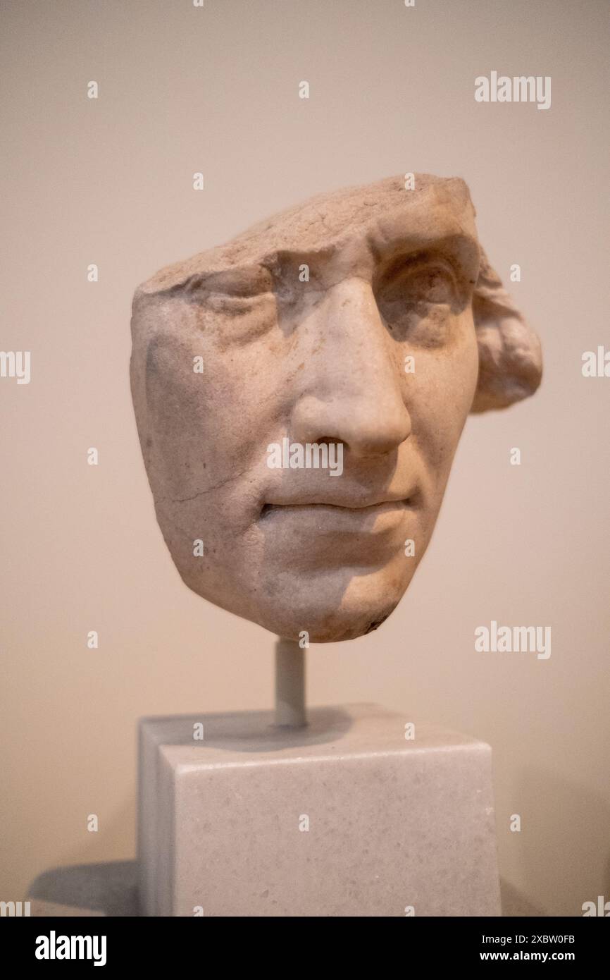 An ancient statue of a face in white marble at the National ...