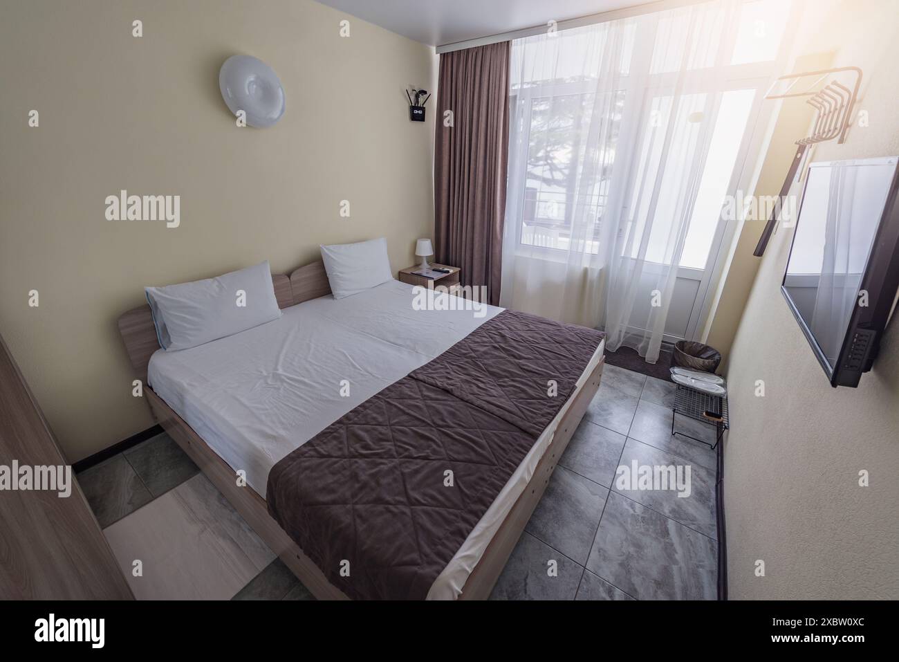 Interior of the small hotel room at sunrise Stock Photo - Alamy