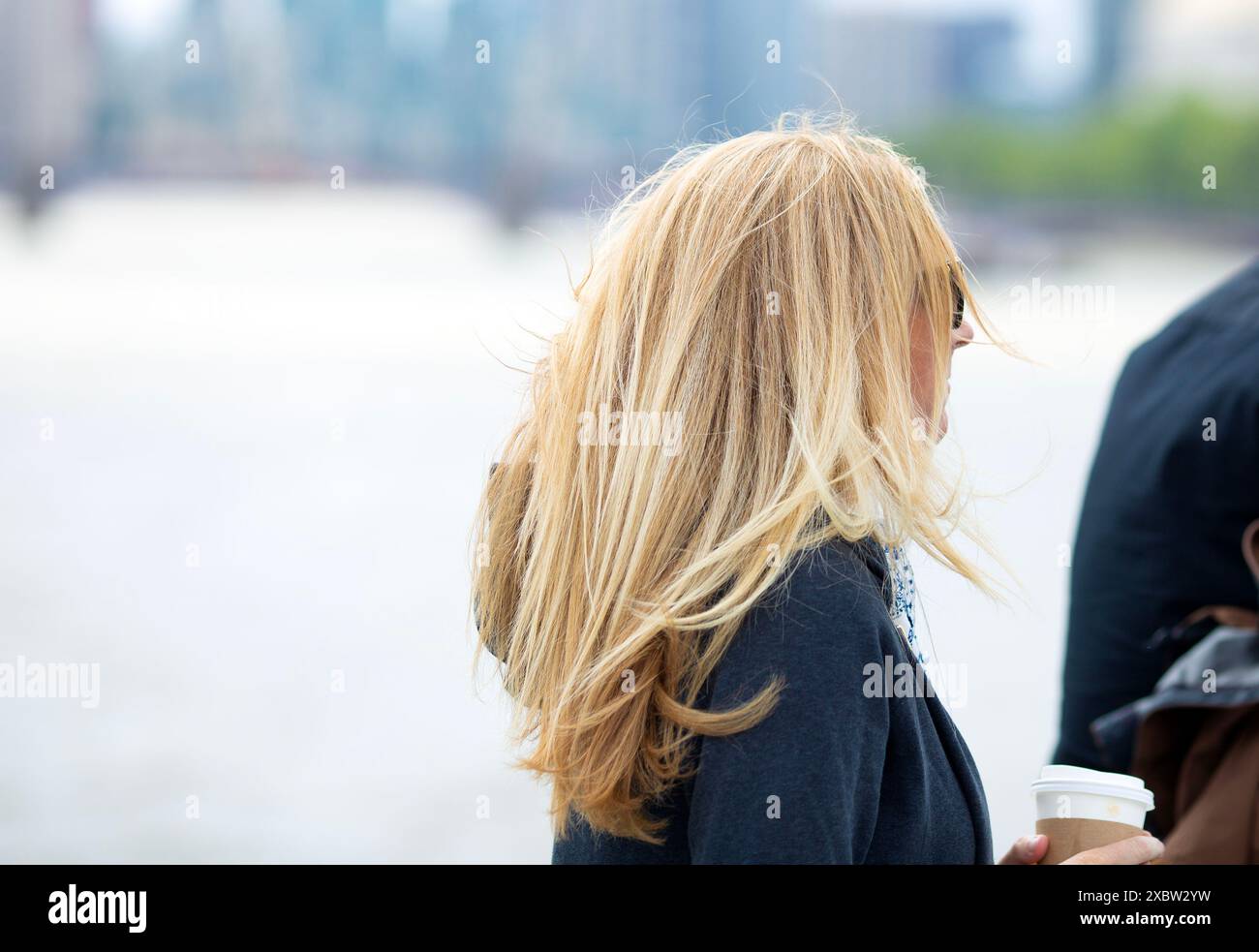 People brave strong winds as they cross Westminster Bridge in London ...