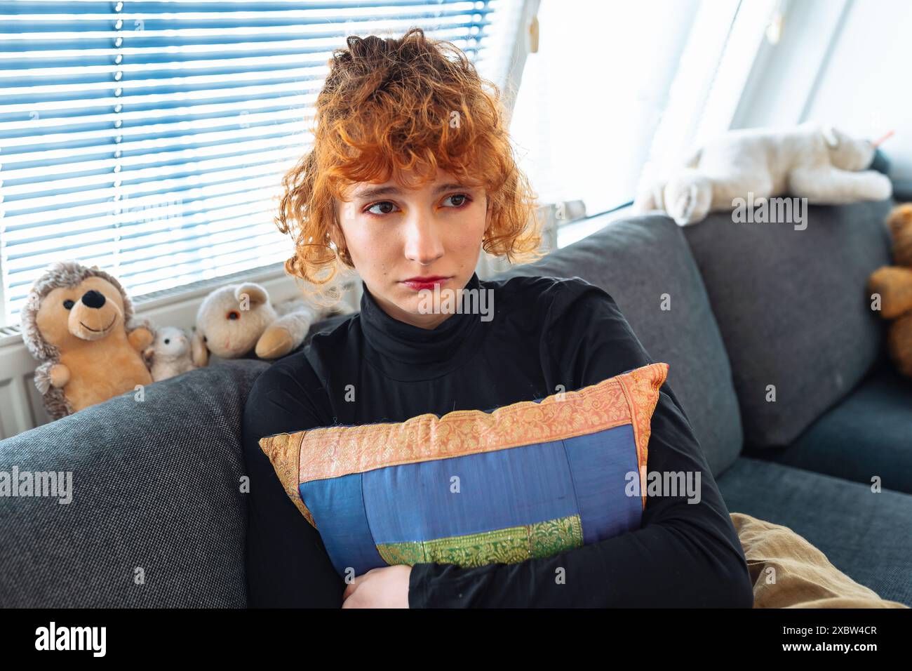 portrait offended crying teenage girl, with red curly hair, sitting on ...