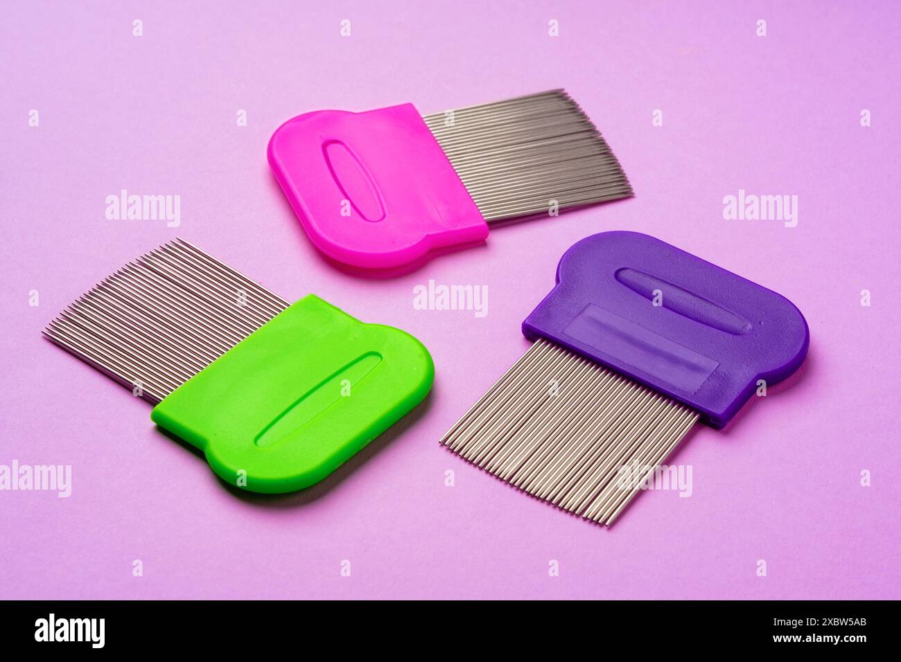 Three combs for removing lice and nits on lilac background Stock Photo ...