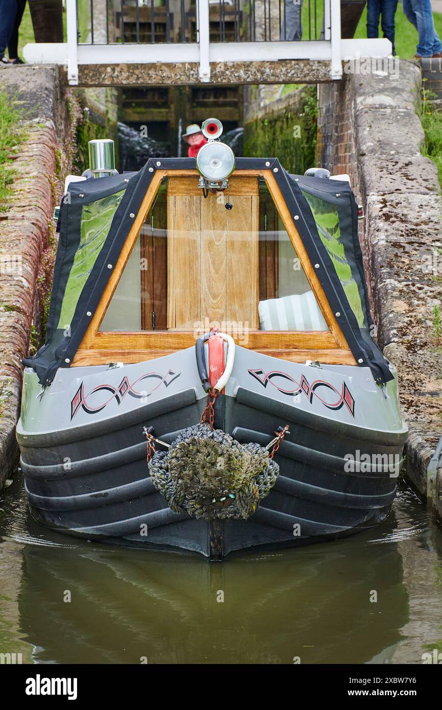 A Canal Boat Negotiates A Lock At The Steepest Flight Of Staircase Locks In Britain Beside The