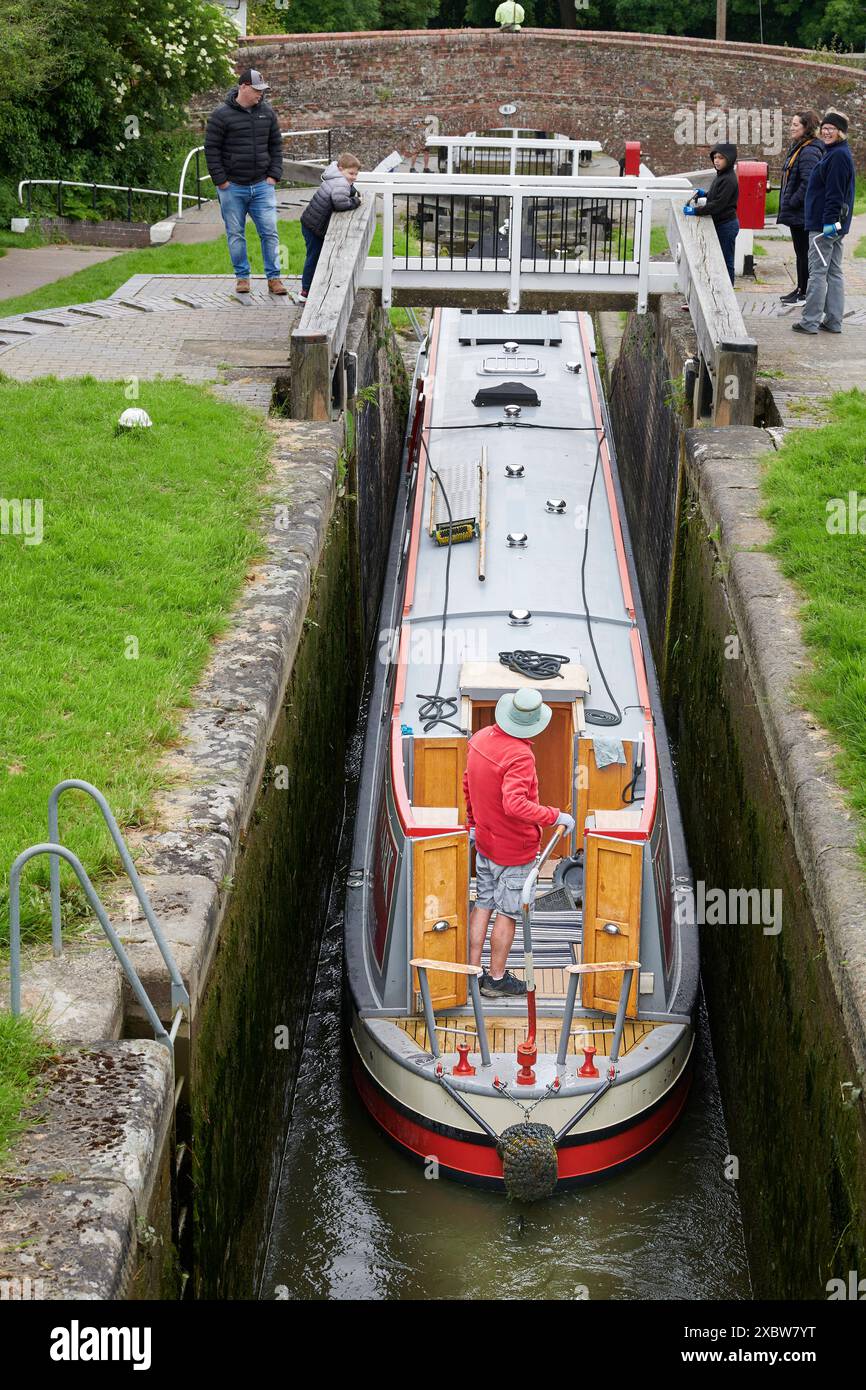 A Canal Boat Negotiates A Lock At The Steepest Flight Of Staircase Locks In Britain Beside The
