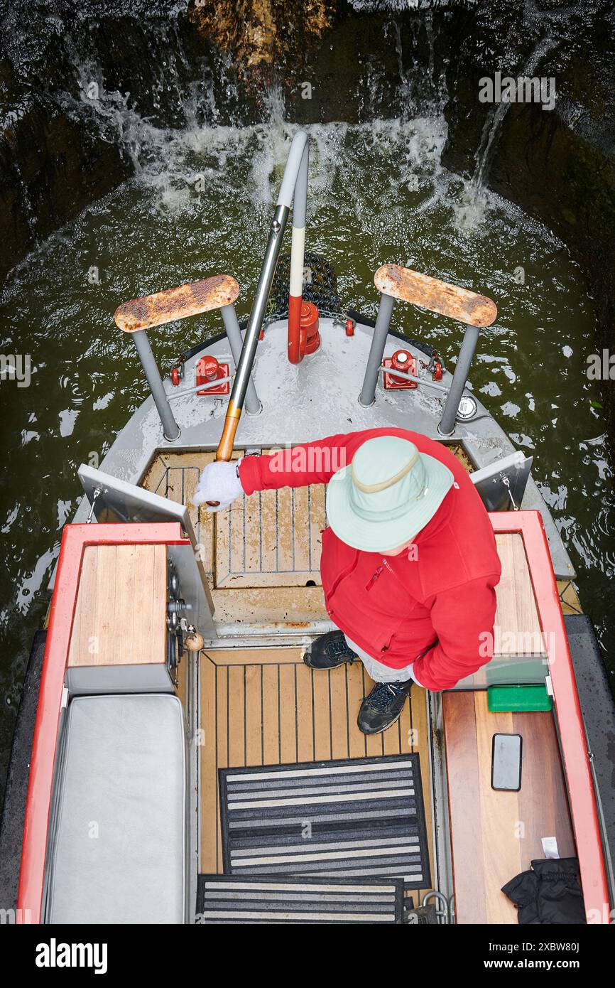 A Canal Boat Negotiates A Lock At The Steepest Flight Of Staircase Locks In Britain Beside The