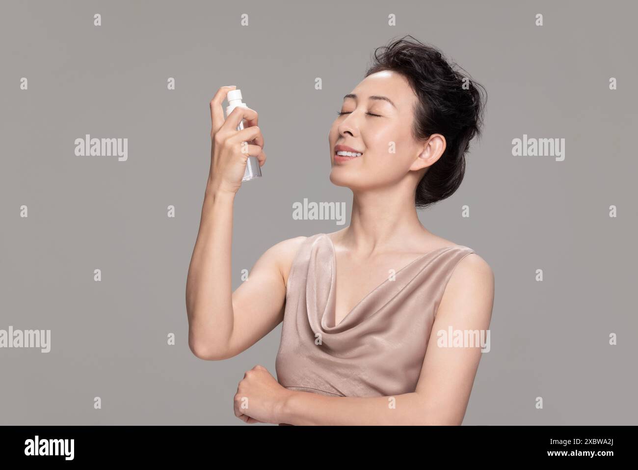 Beautiful Woman Using Hydrating Face Spray Stock Photo - Alamy