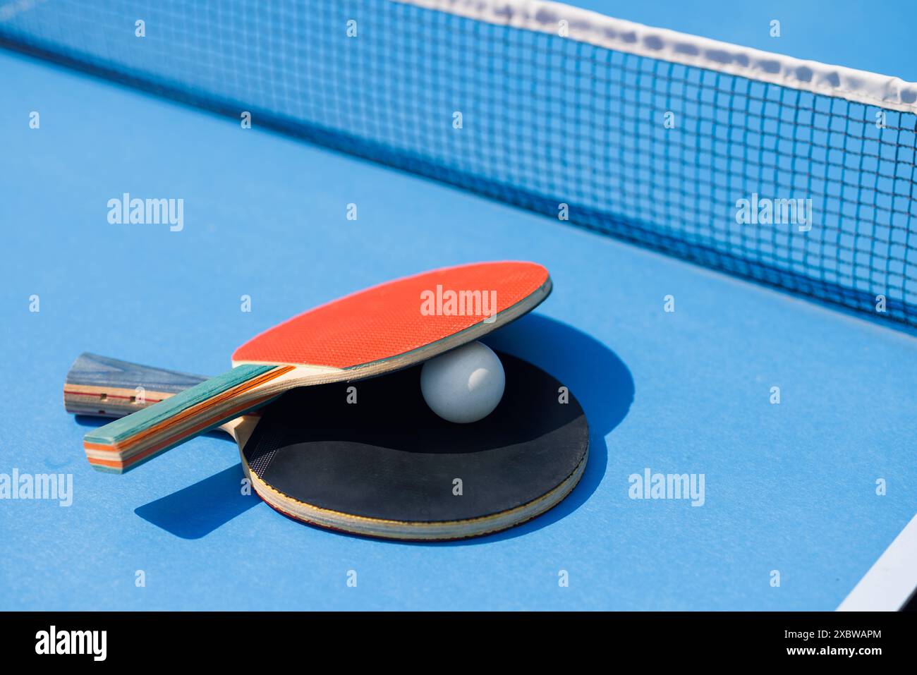 tennis rackets for playing ping pong on blue table, ping pong concept ...