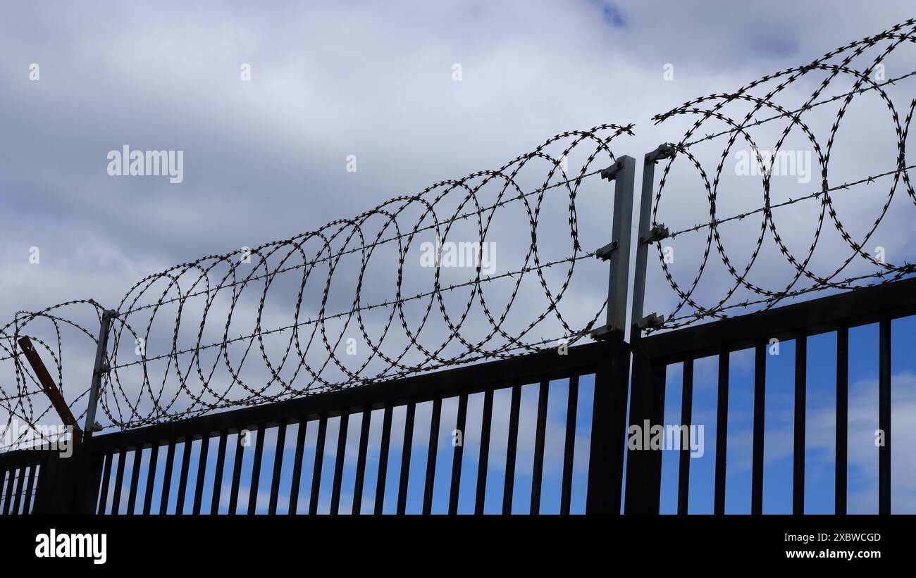 Gosport, Hampshire, England. 1 June 2024: Razor wire over the gates of ...