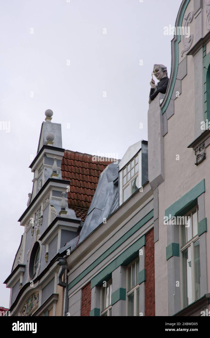 Peeping Tom bust peers through his lorgnette spectacles from a rooftop ...