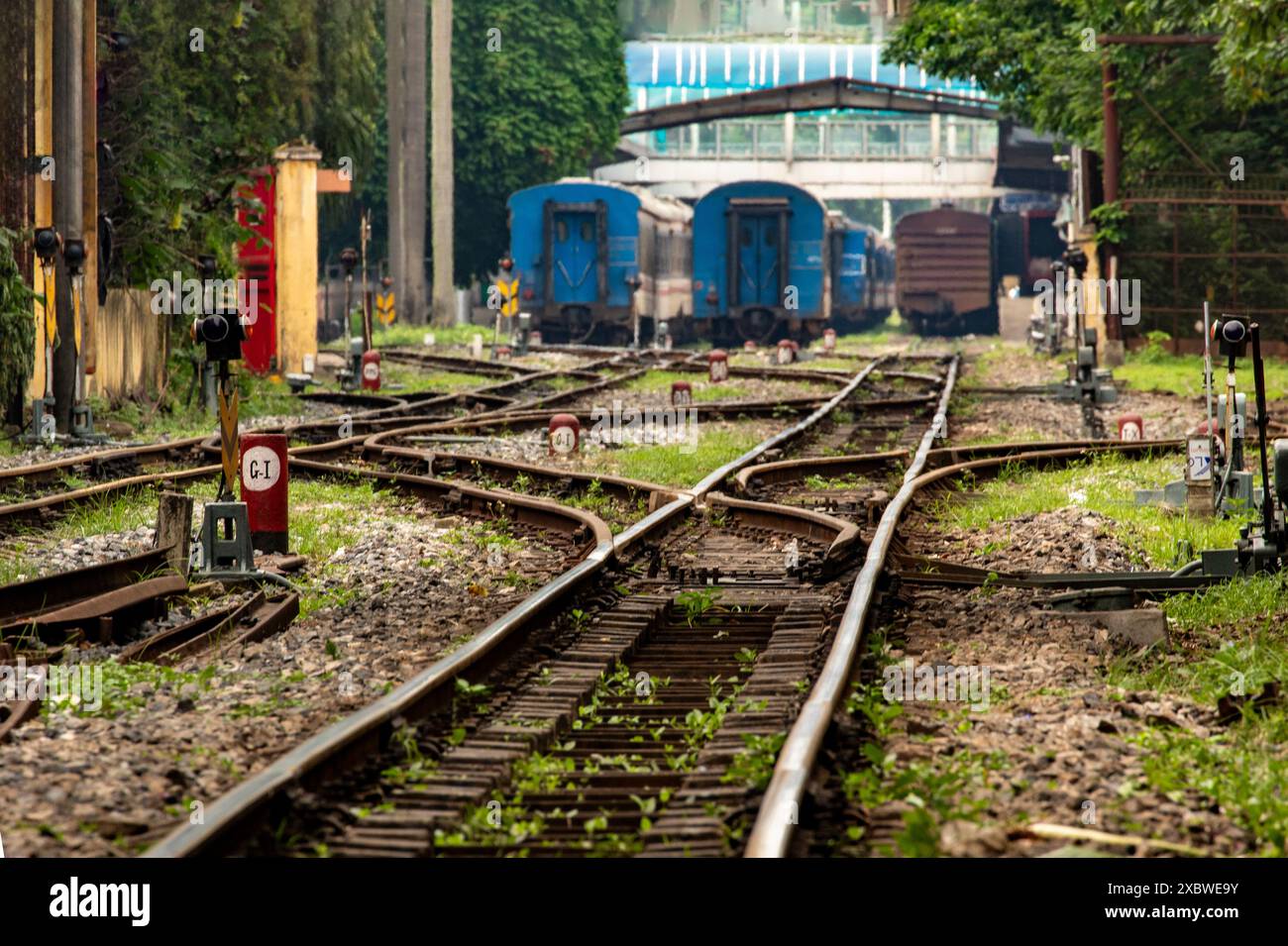 Rail track and blue Hanoi (Vietnam) 'Doorway Railway' train at rest ...