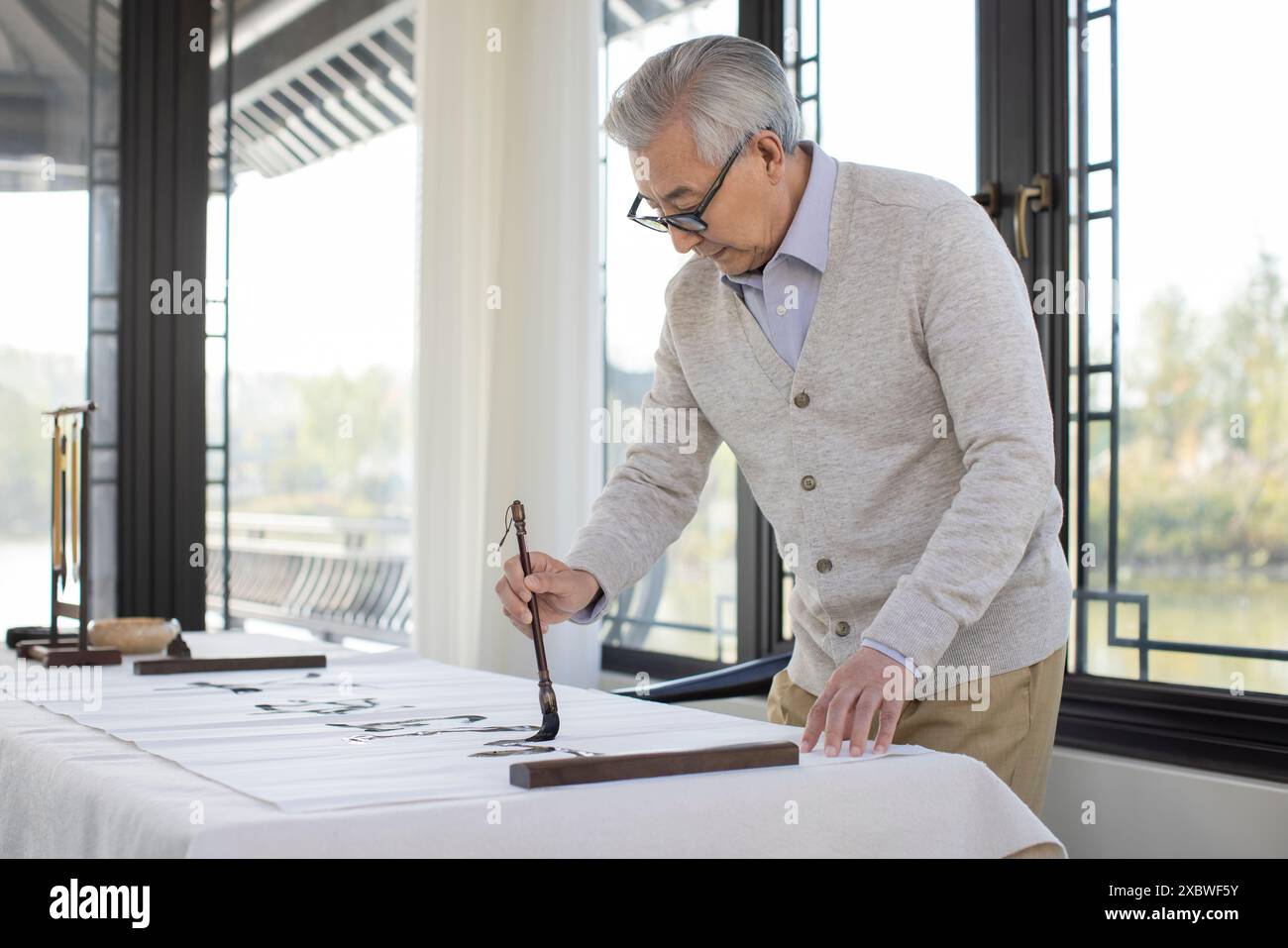 Senior Man Practicing Chinese Calligraphy Stock Photo - Alamy