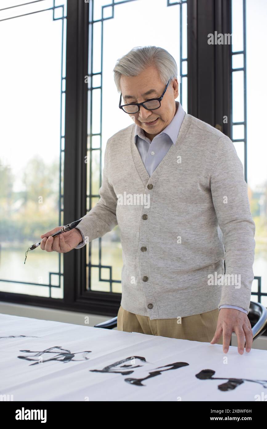 Senior Man Practicing Chinese Calligraphy Stock Photo - Alamy