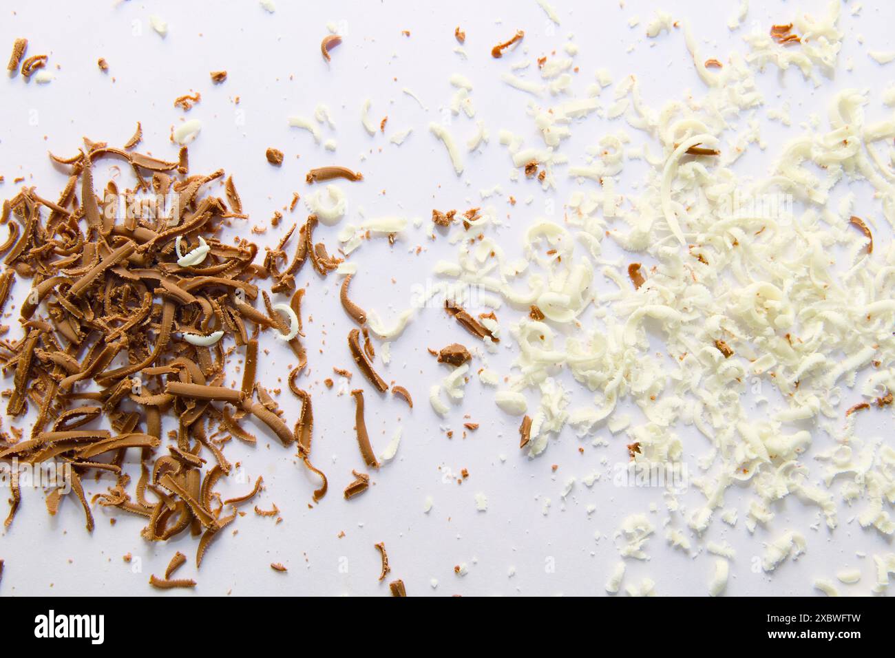 A heap of finely grated chocolate shavings on a pristine white surface ...
