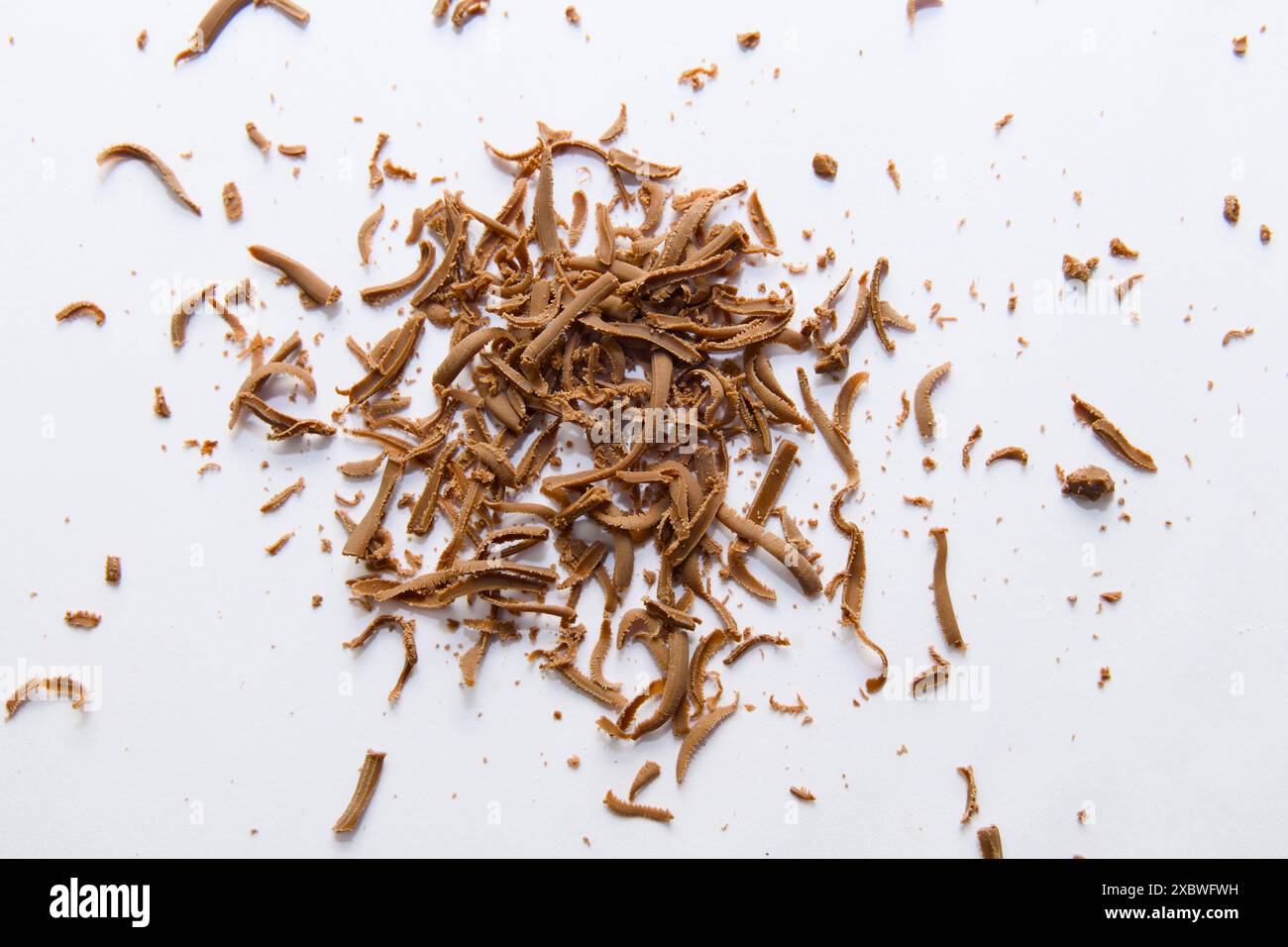 A heap of finely grated chocolate shavings on a pristine white surface ...