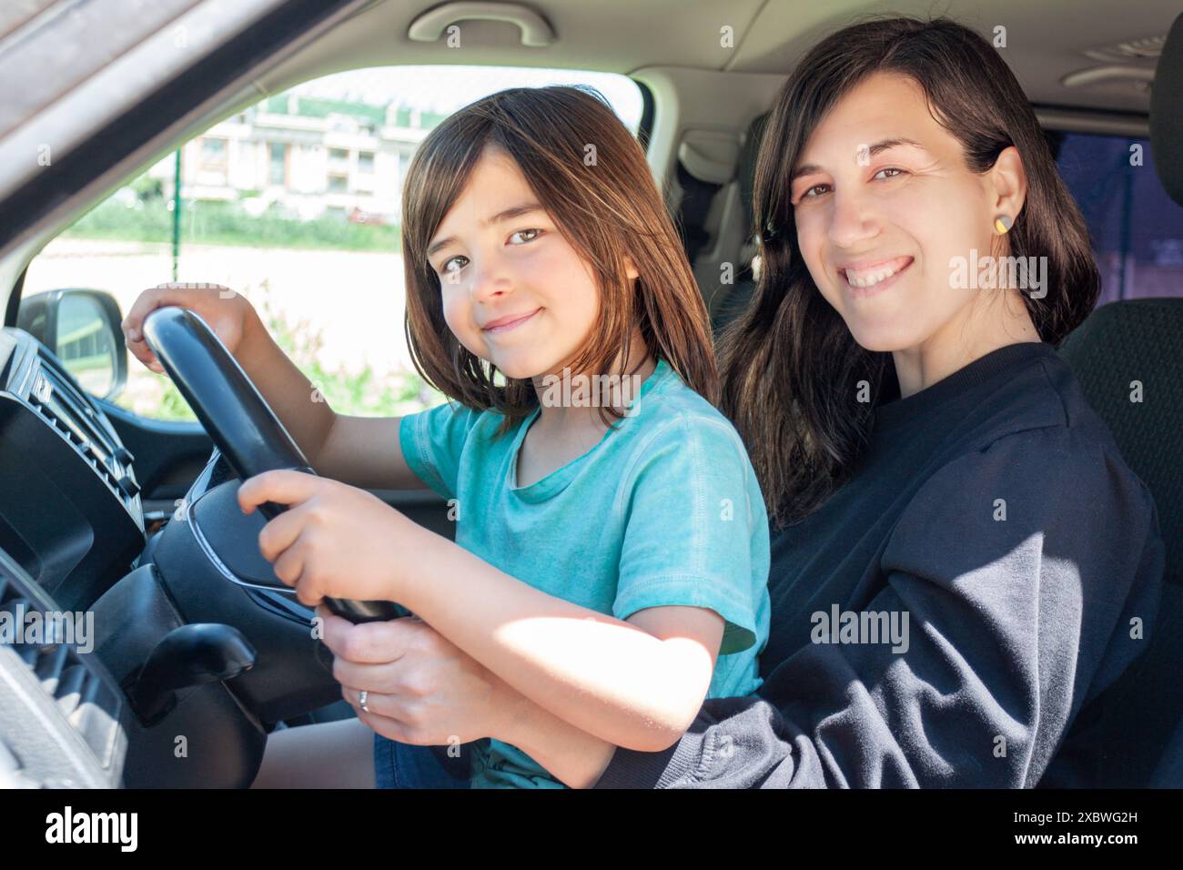 Mother and son smiling in the driver's seat. Transportation and family ...