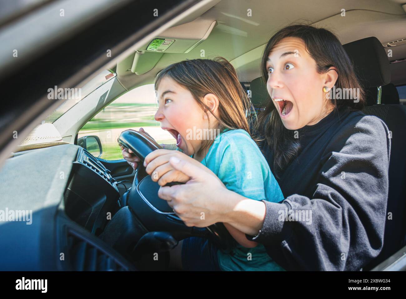 Mother and son behind the wheel of the vehicle and speed face ...