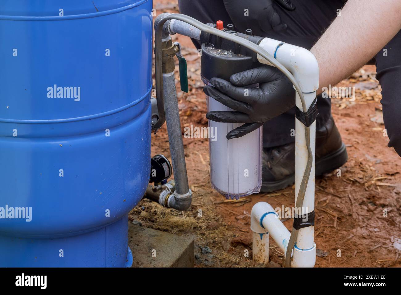 Worker maintenance work replaces at domestic water treatment ...