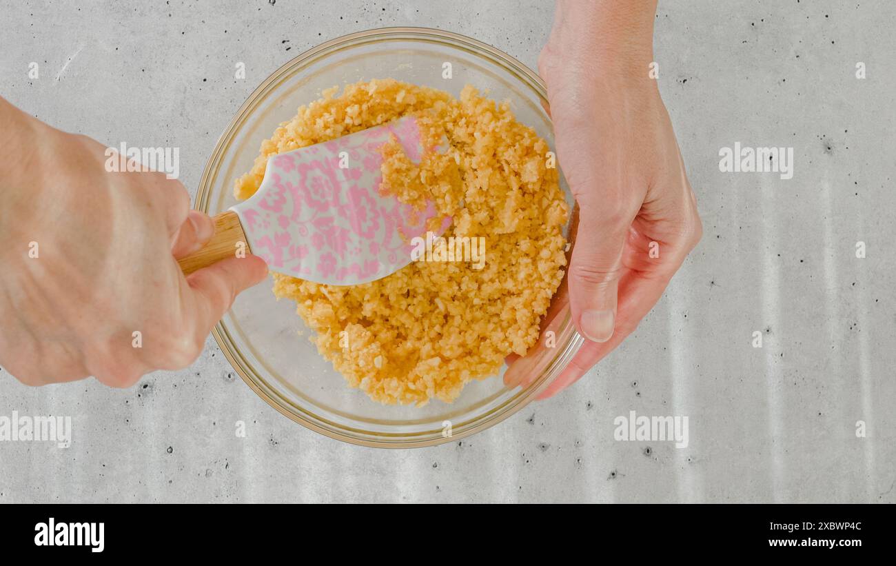 Cracker crust for cheesecake recipe. Mixing crushed crackers with ...