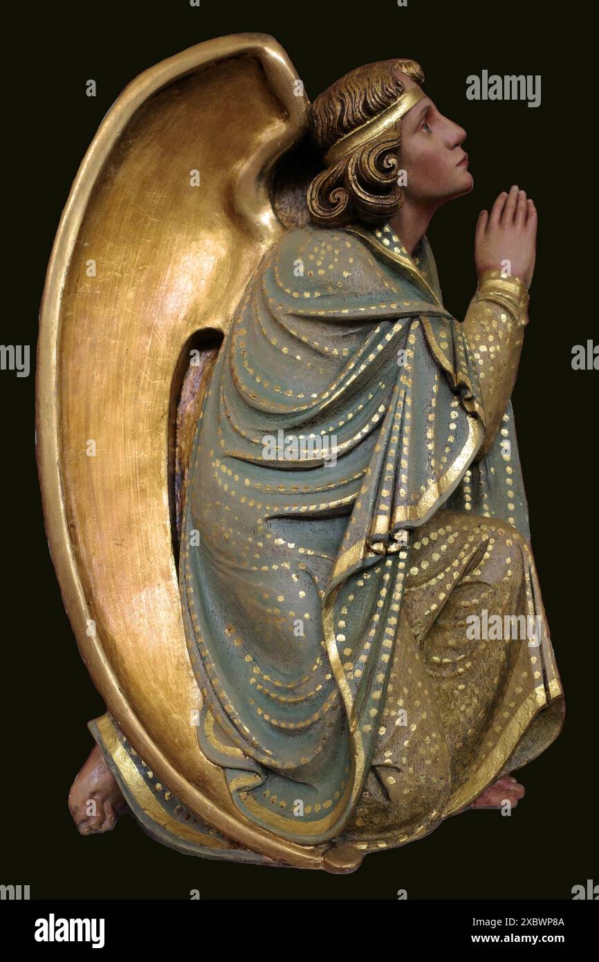 Small statue of a praying angel in a church, on black background Stock ...