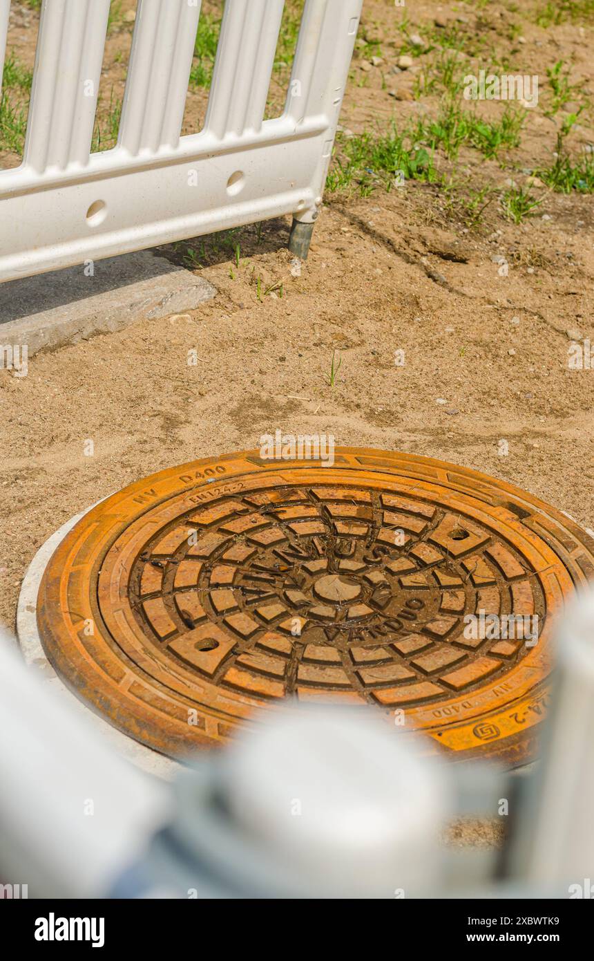 Rusty iron manhole cover in a ditch. High quality photo Stock Photo - Alamy