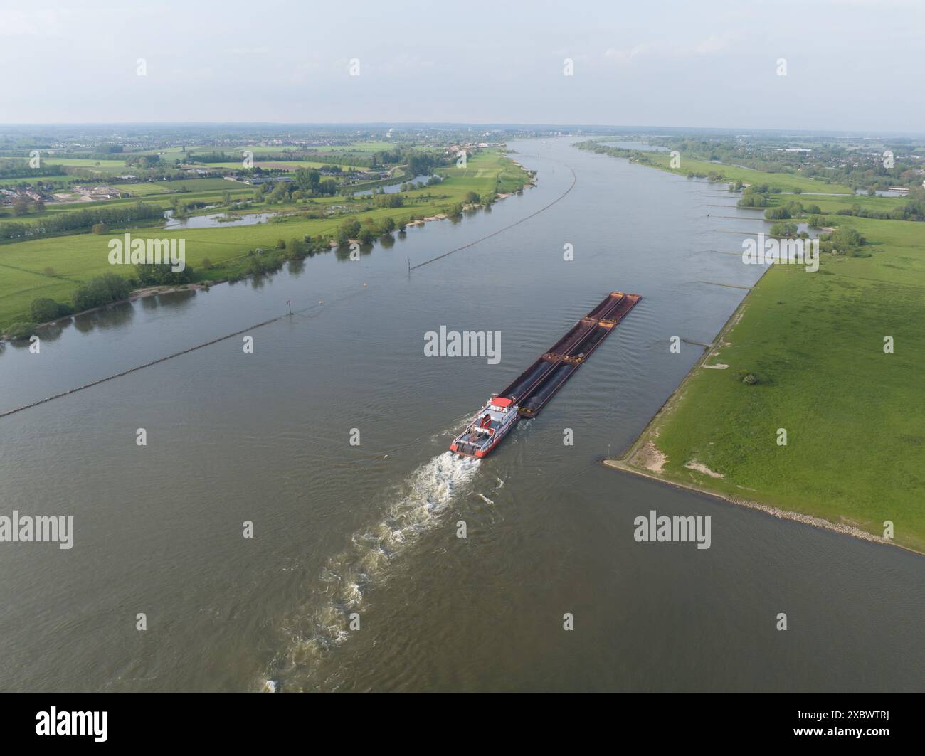 Aerial view on the Waal river, Motor tanker inland shipping barge ...