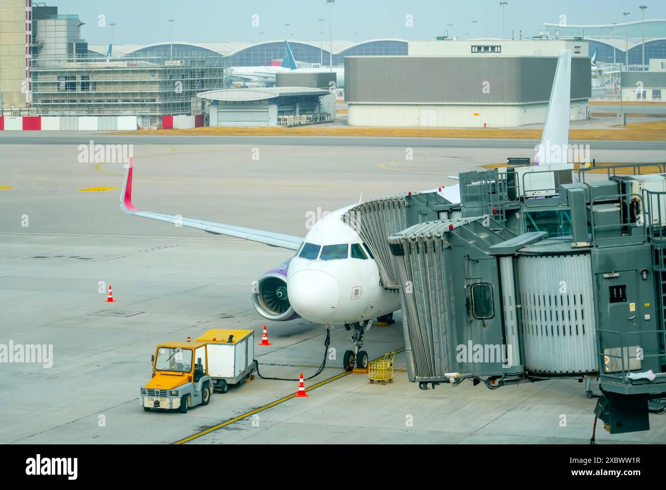 Airplane jet connected to terminal via jet bridge Stock Photo - Alamy