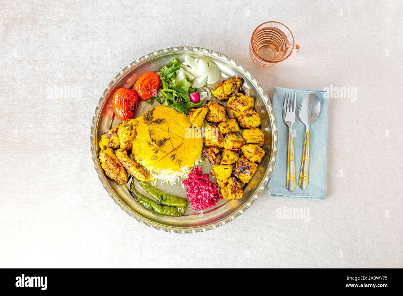 Colorful Persian food on a white background consists of chicken kebab ...