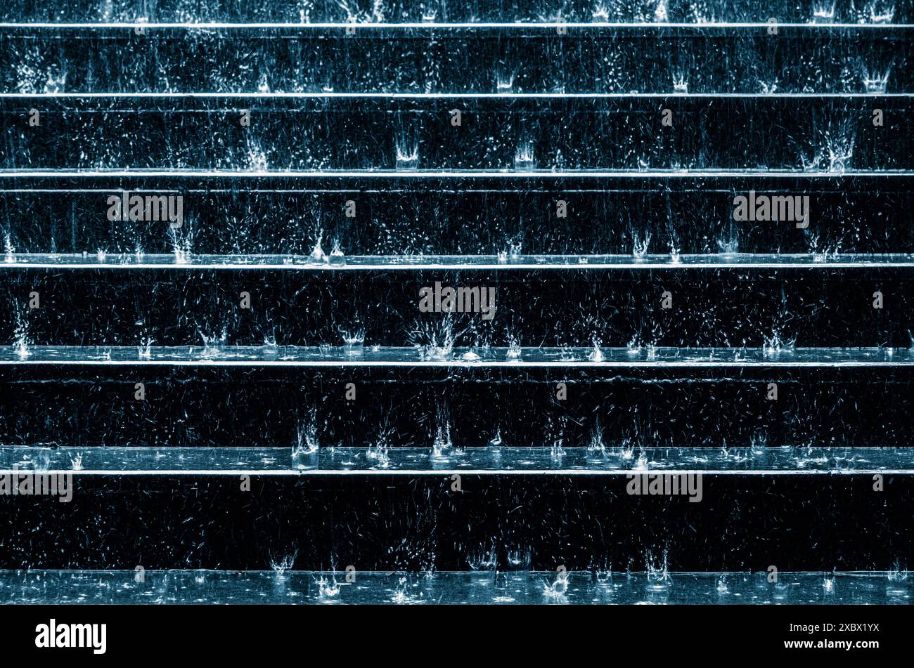 Heavy rain droplets are seen falling on concrete stairs Stock Photo - Alamy