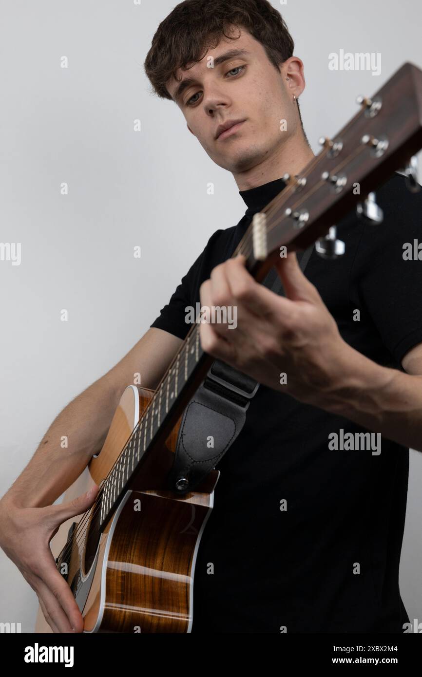 Young male guitarist playing hi-res stock photography and images - Alamy