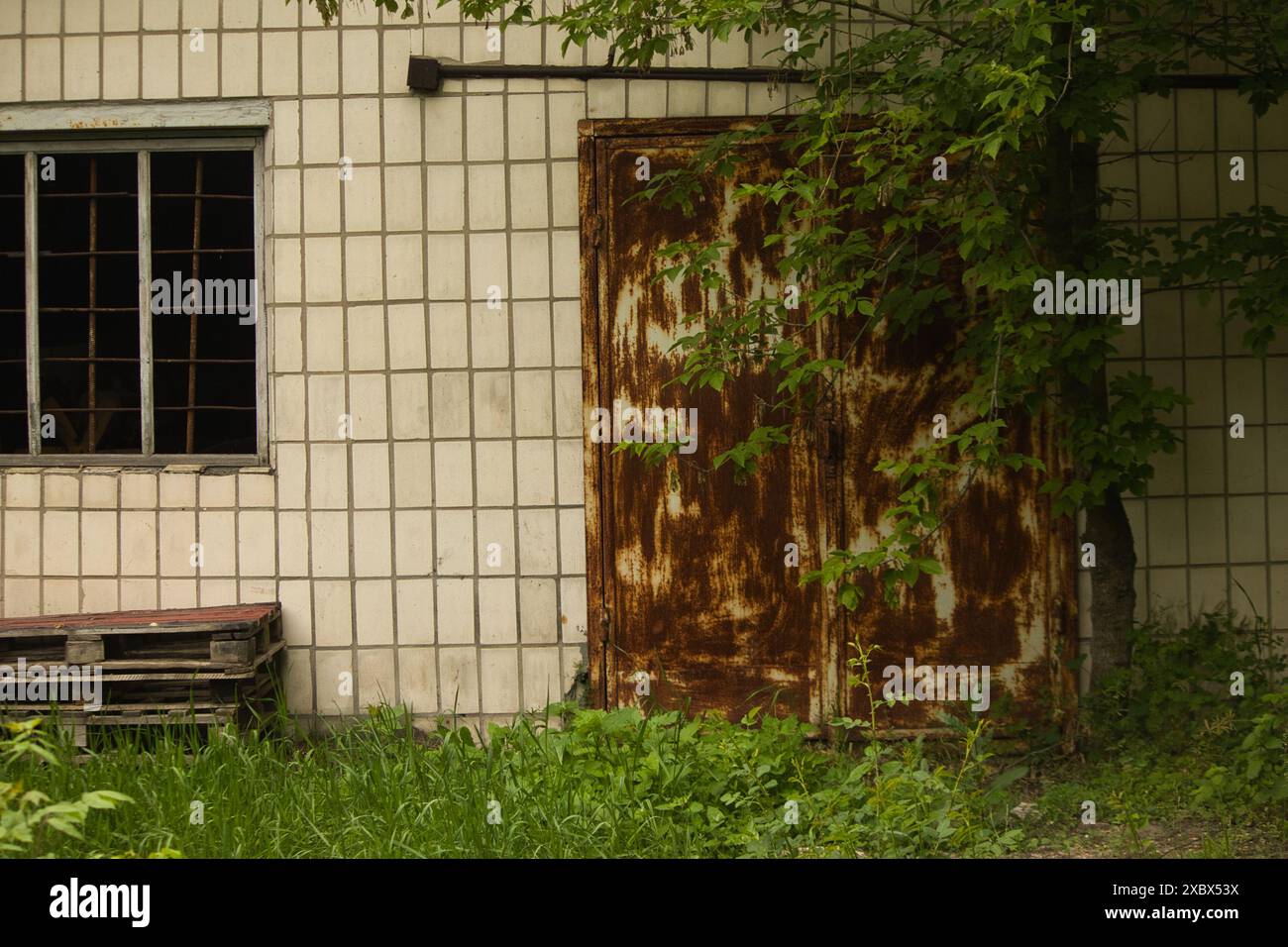 old abandoned building, broken window and rusty metal old door Stock Photo - Alamy
