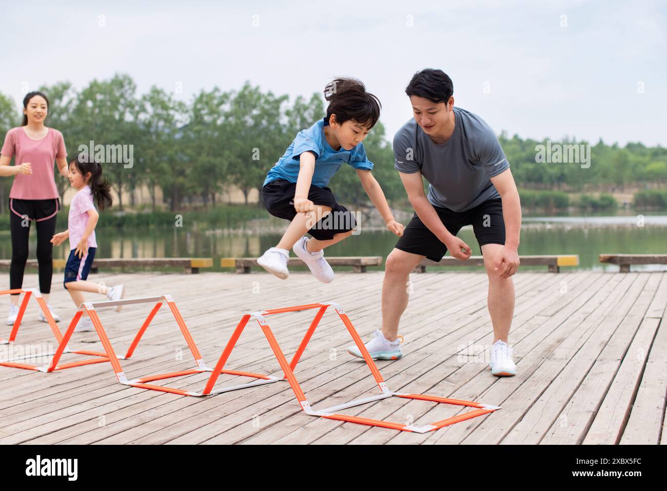 Family Exercising With Agility Ladder Stock Photo - Alamy