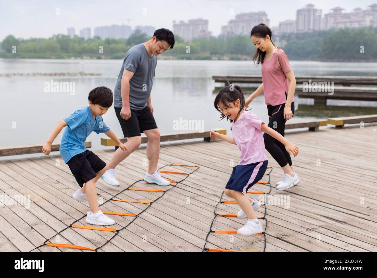 Family Exercising With Agility Ladder Stock Photo - Alamy