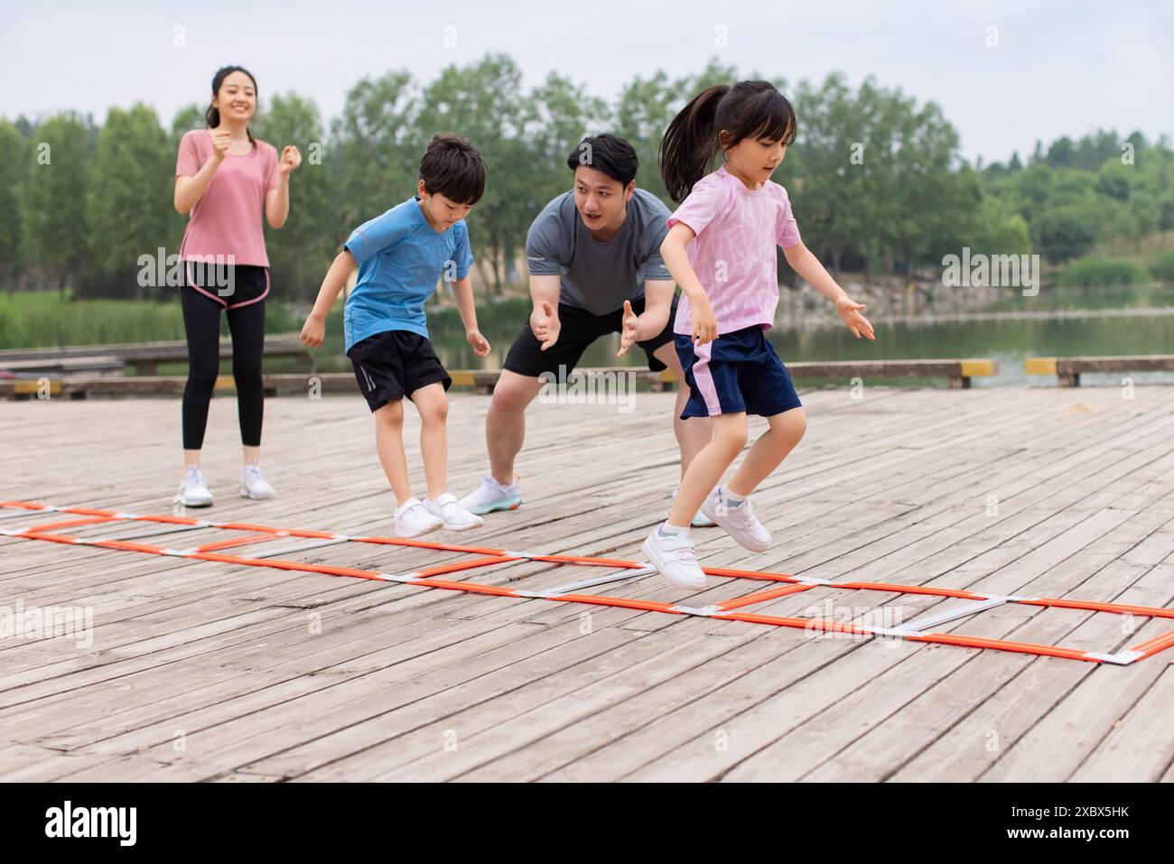 Family Exercising With Agility Ladder Stock Photo - Alamy