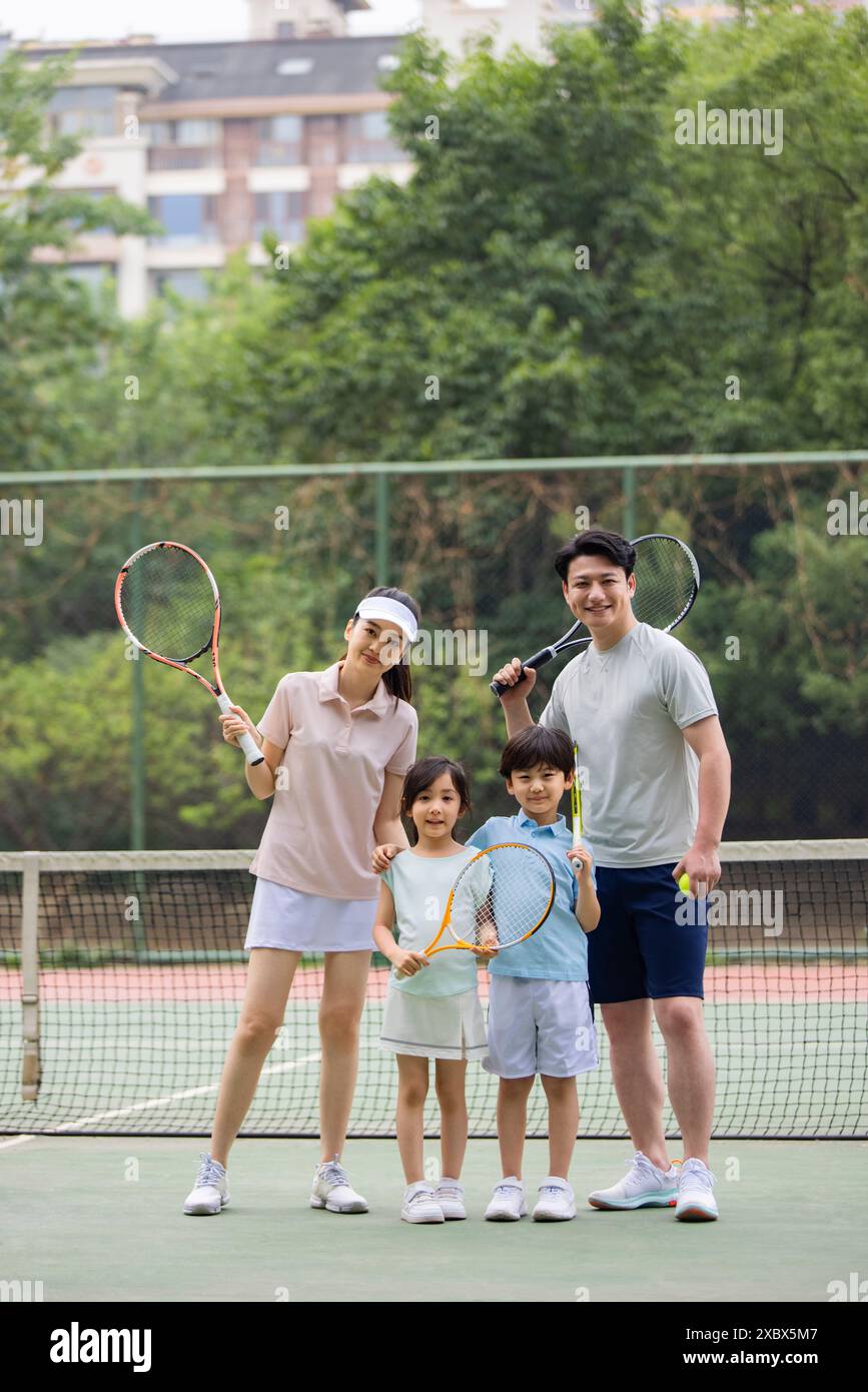 Family Playing Tennis On The Tennis Court Stock Photo - Alamy