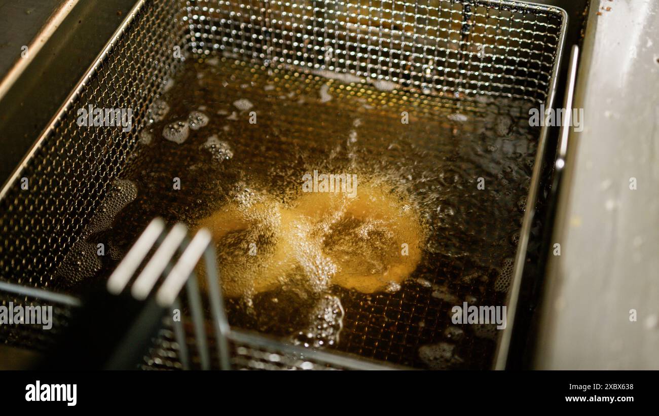 Onion Rings Boiling In Oil Stock Photo - Alamy